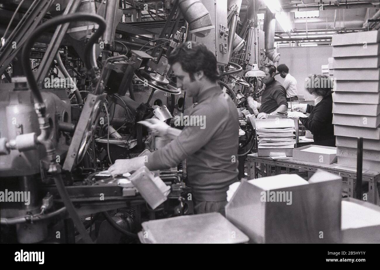 1970s, historical, inside a record manufacturing factory, male workers ...