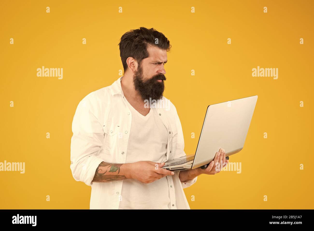 hard working. Programmer with computer. brutal man surfing internet ...