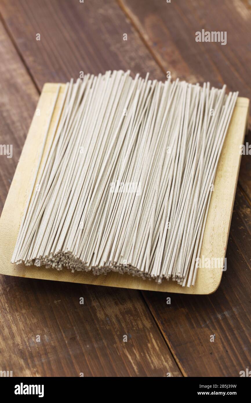 dried Soba ( Japanese buckwheat noodles) isolated on wooden background ...