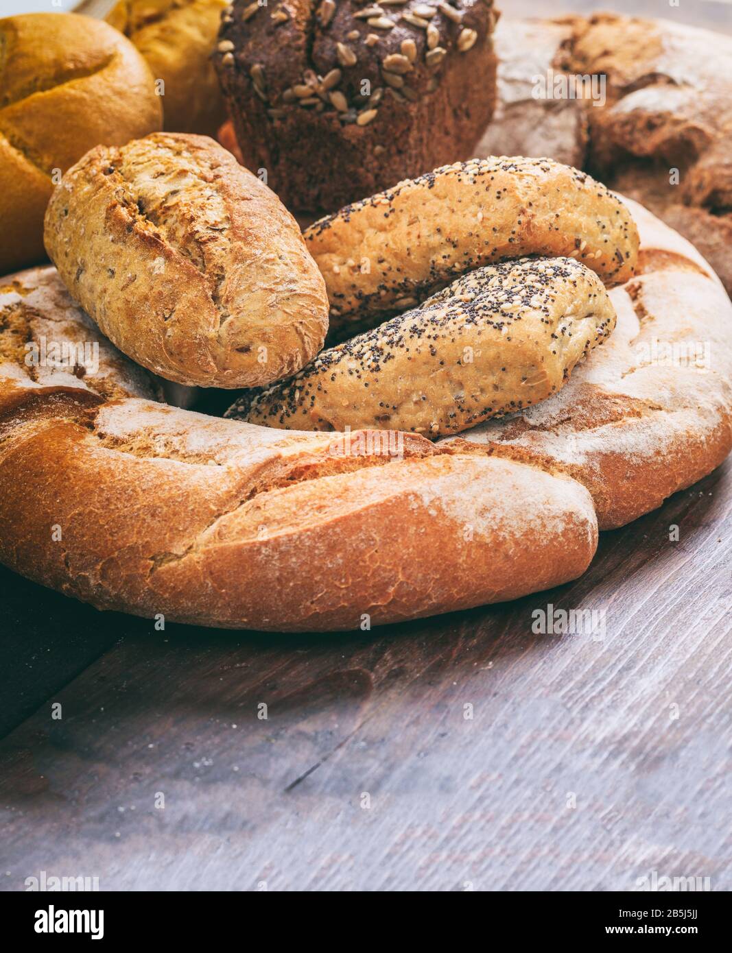 Bakery concept. Bread loaves assortment on wood. Traditional bakehouse ...