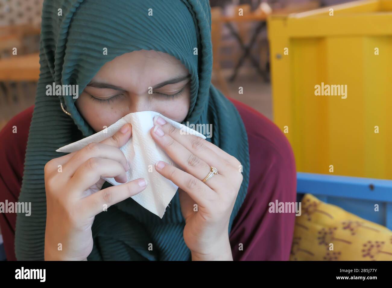 Closeup on ill elegant woman wiping nose with napkin Stock Photo - Alamy
