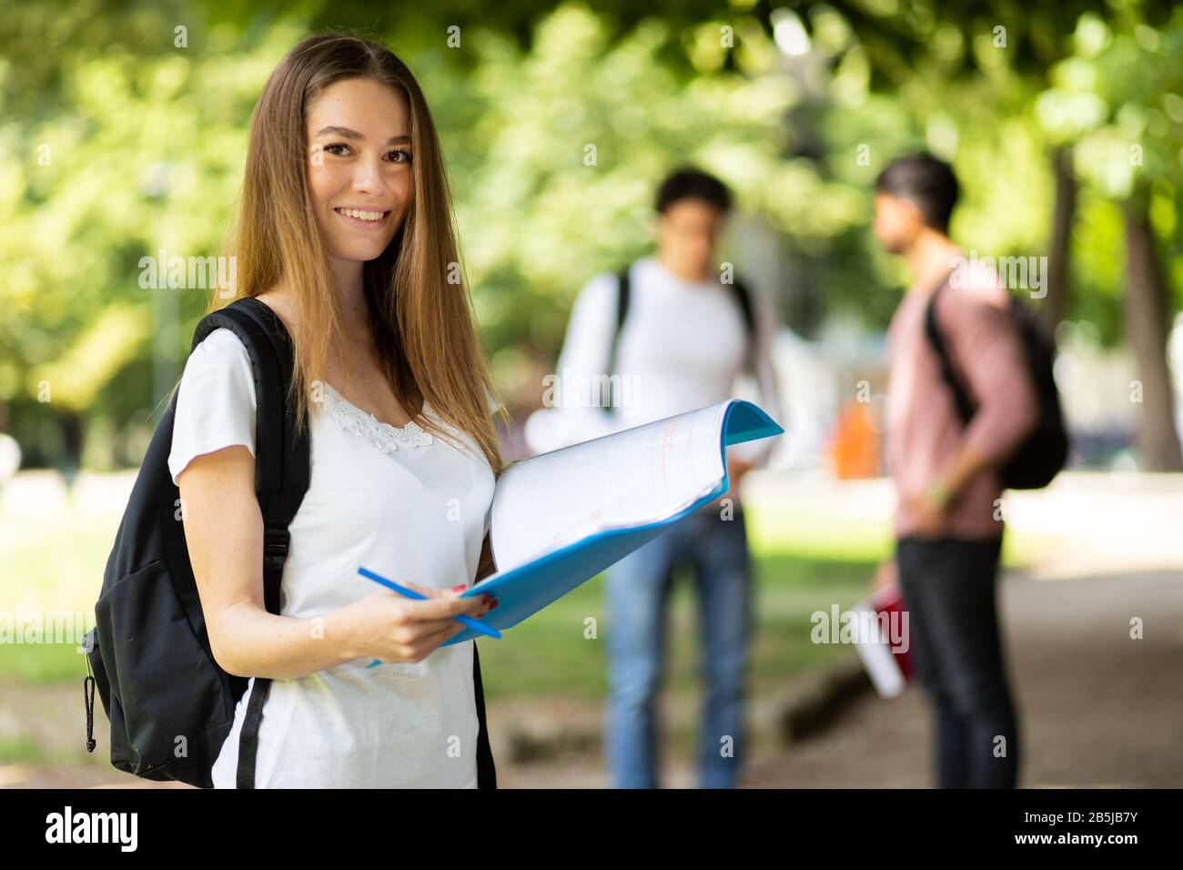 Happy students outdoor smiling Stock Photo - Alamy