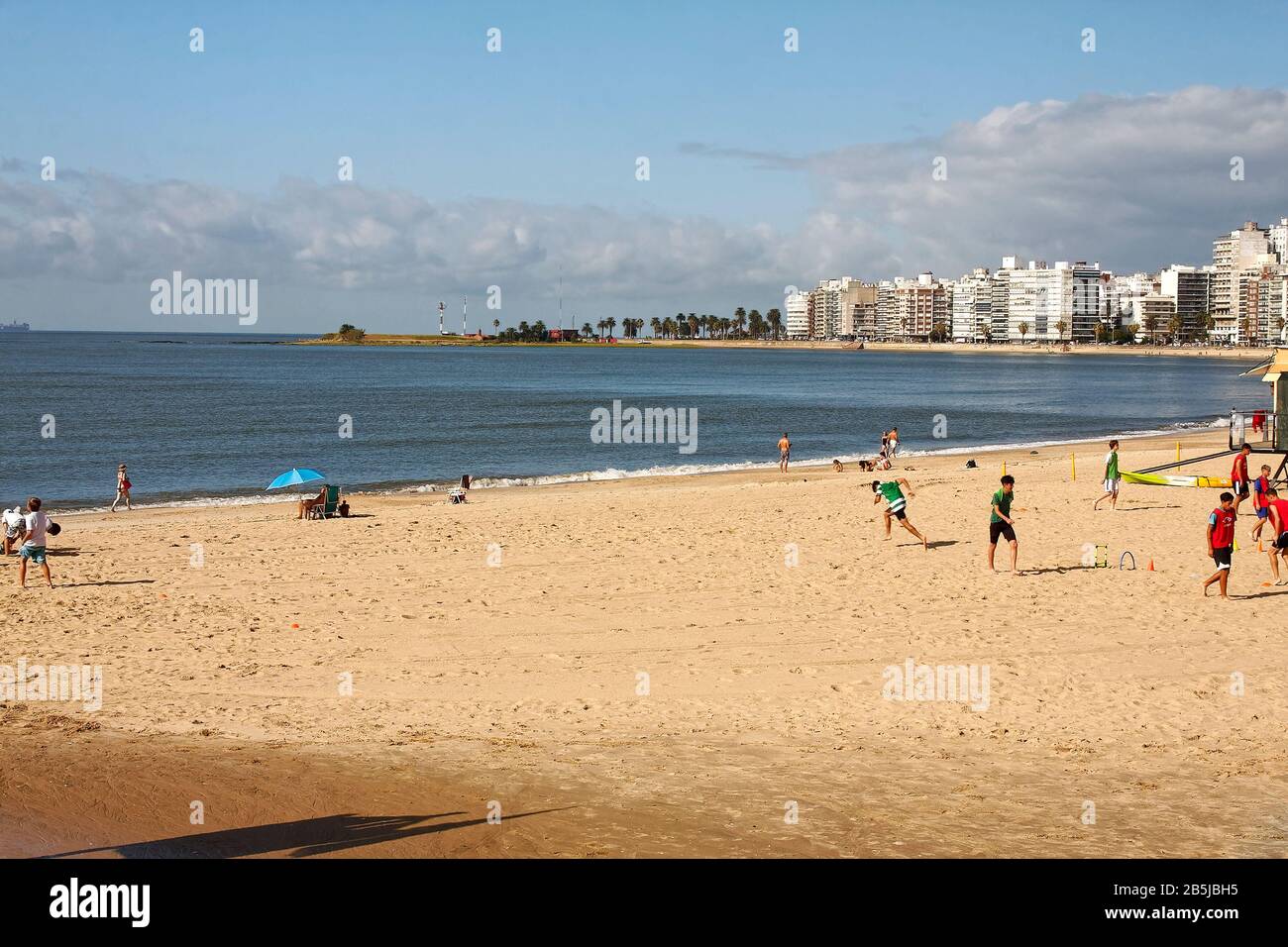 cityscape, beach scene, condos; hotels; people playing; walking ...