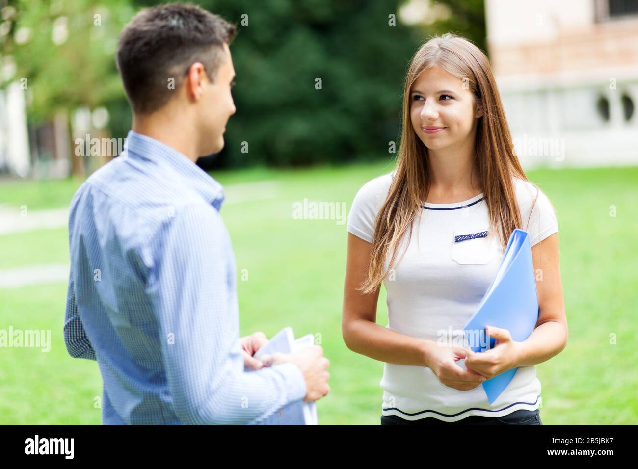 Couple of students talking together Stock Photo - Alamy