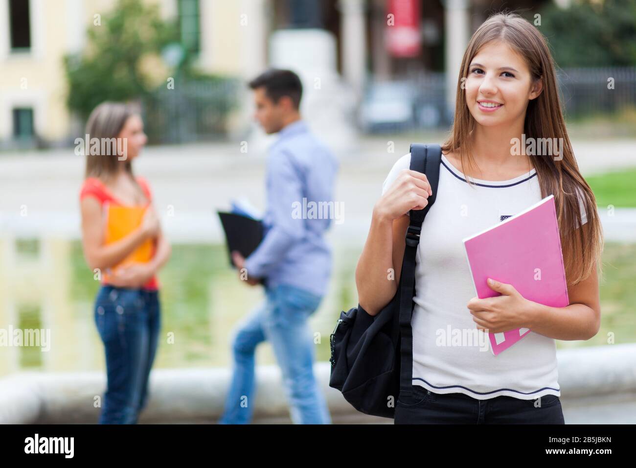 Happy students outdoor smiling Stock Photo - Alamy