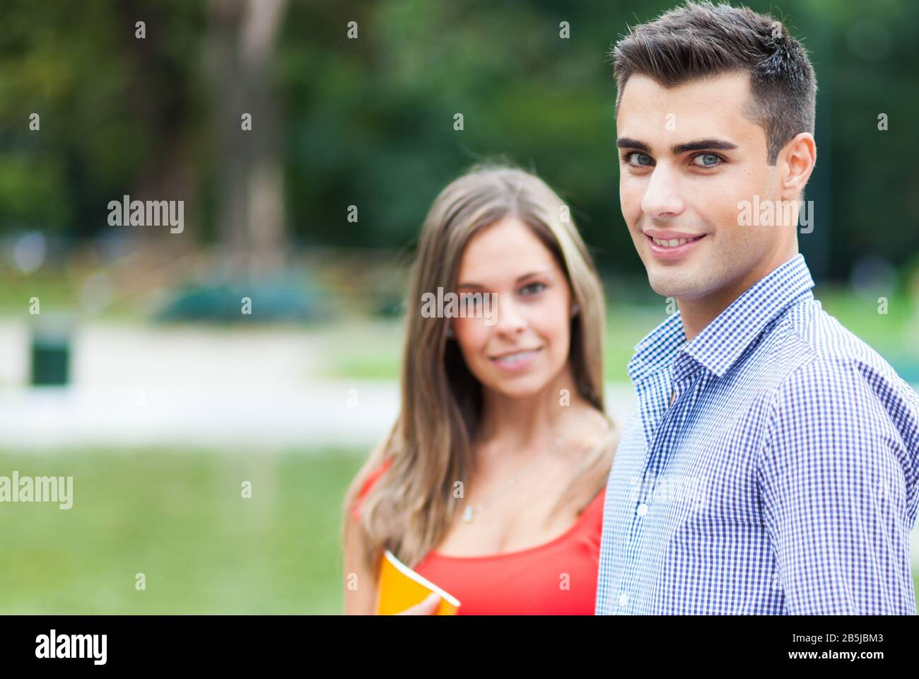 Happy students outdoor smiling Stock Photo - Alamy