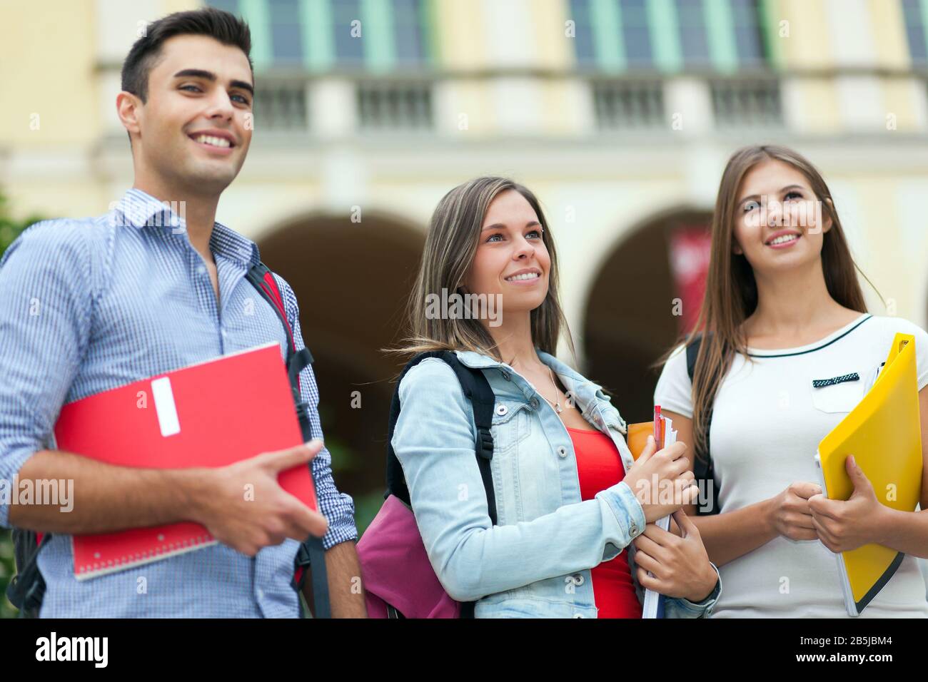 Happy students outdoor smiling Stock Photo - Alamy