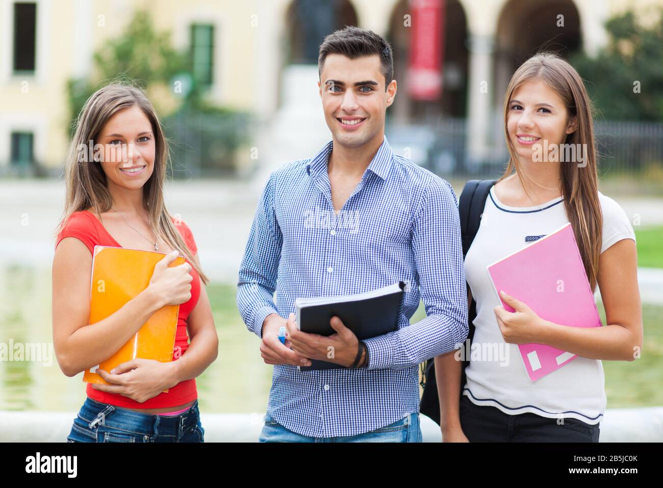 Happy students outdoor smiling Stock Photo - Alamy