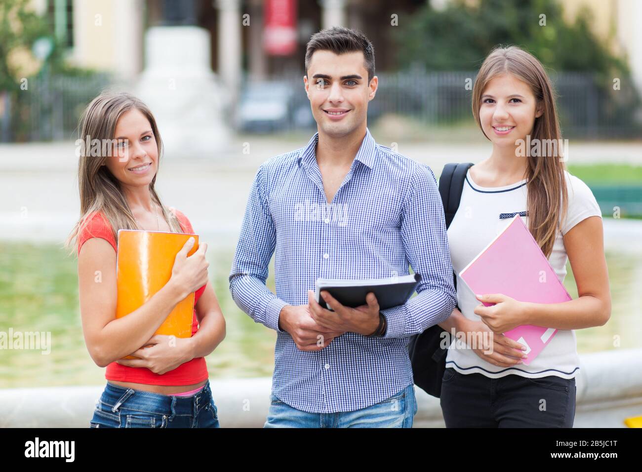 Happy students outdoor smiling Stock Photo - Alamy