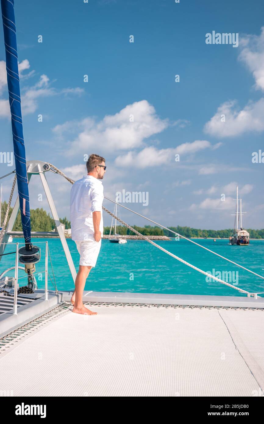 Seychelles, young men on vacation with sailing boat at the Seychelles ...