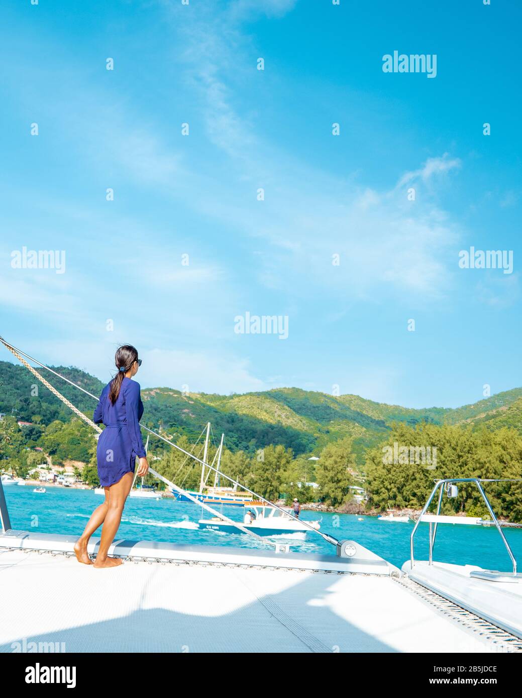 Seychelles, young men on vacation with sailing boat at the Seychelles ...