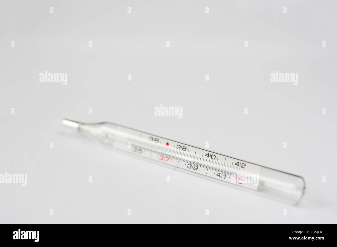 Mercury thermometer, on white background showing 39 degrees Celsius ...
