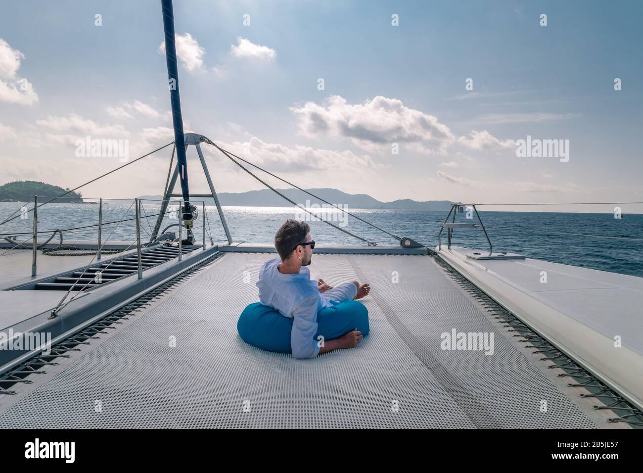 Seychelles, young men on vacation with sailing boat at the Seychelles ...