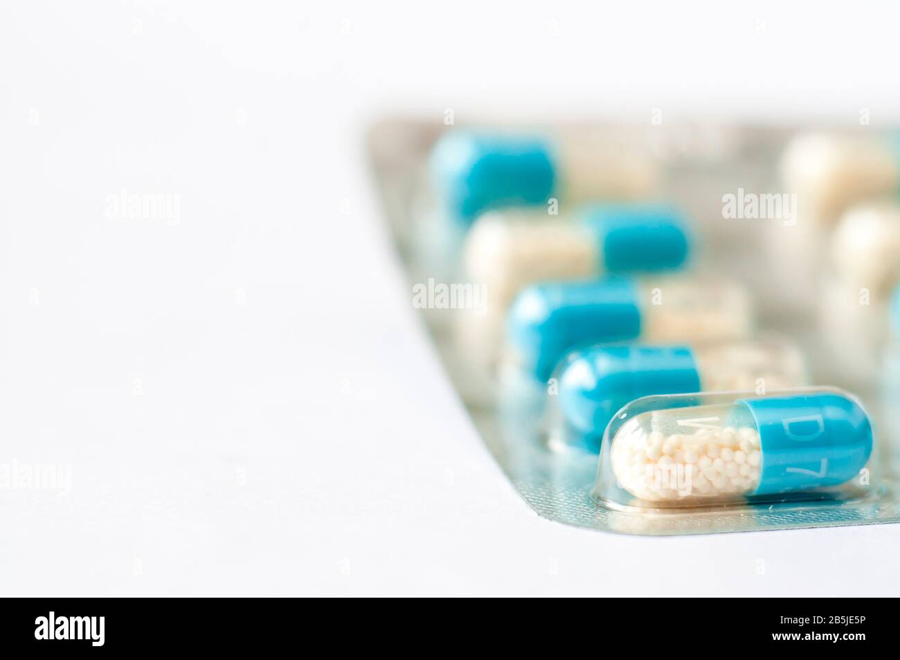 Closeup blue-white antibiotics capsule pills in blister pack. Pharmacy ...