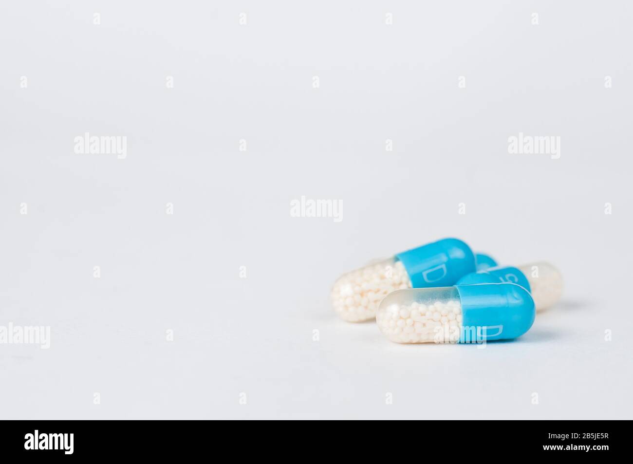 Closeup blue-white antibiotics capsule pills. Pharmacy background ...