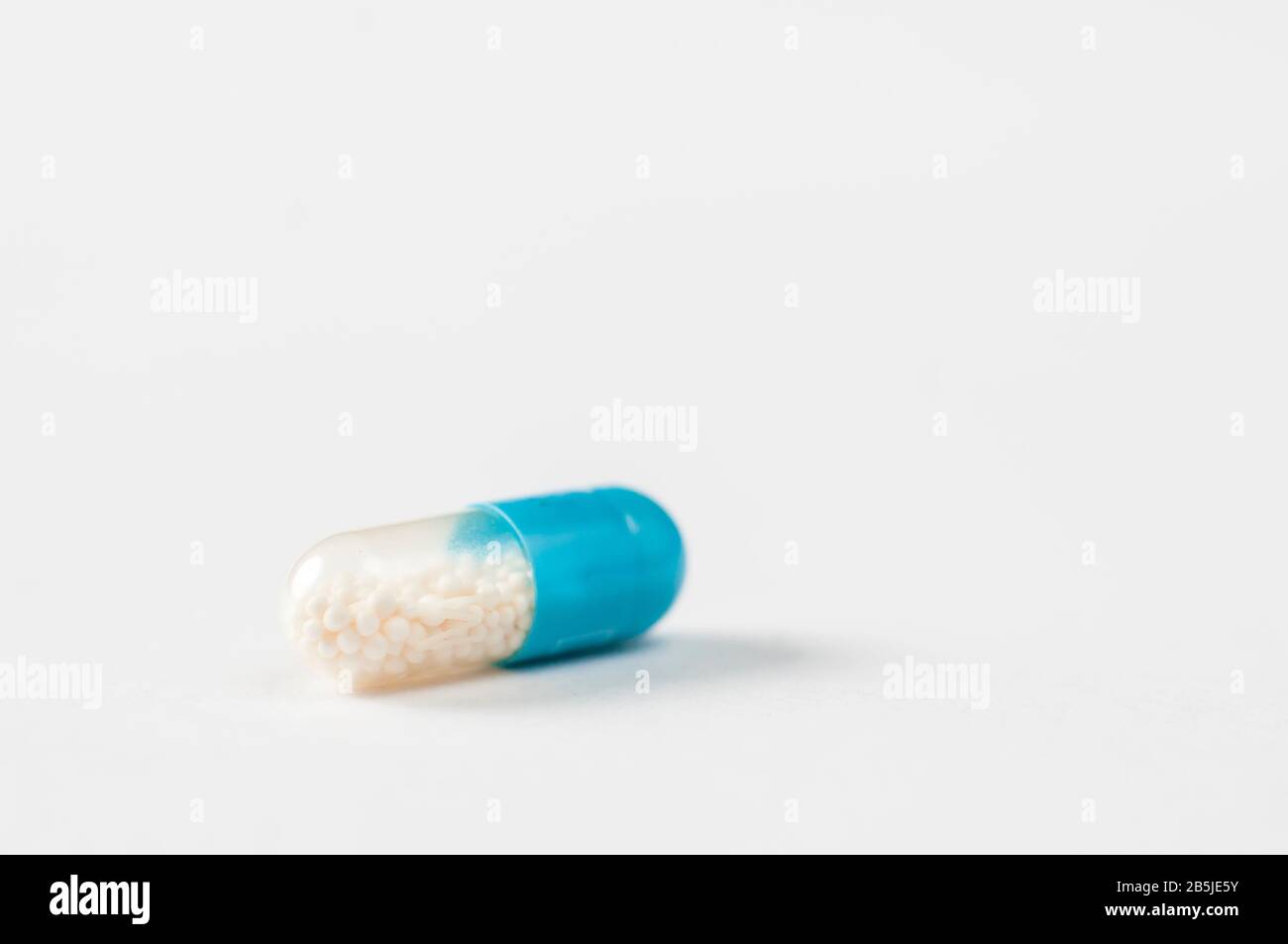 Closeup blue-white antibiotics capsule pills. Pharmacy background ...