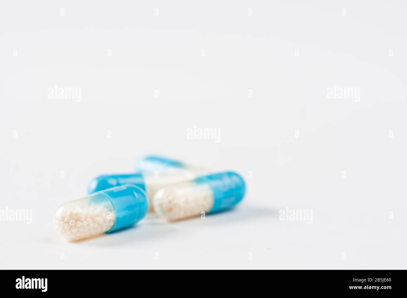 Closeup blue-white antibiotics capsule pills. Pharmacy background ...