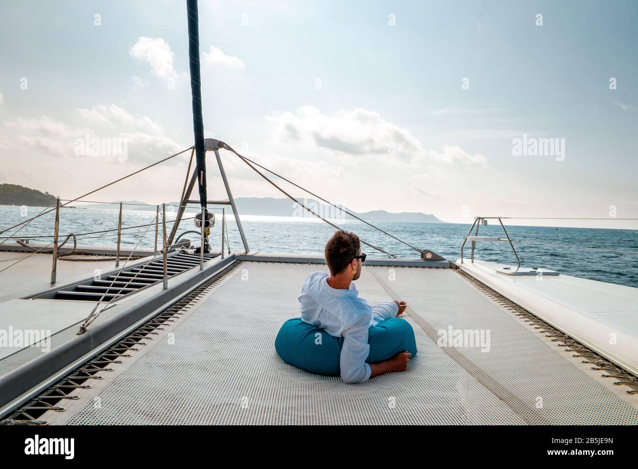 Seychelles, young men on vacation with sailing boat at the Seychelles ...