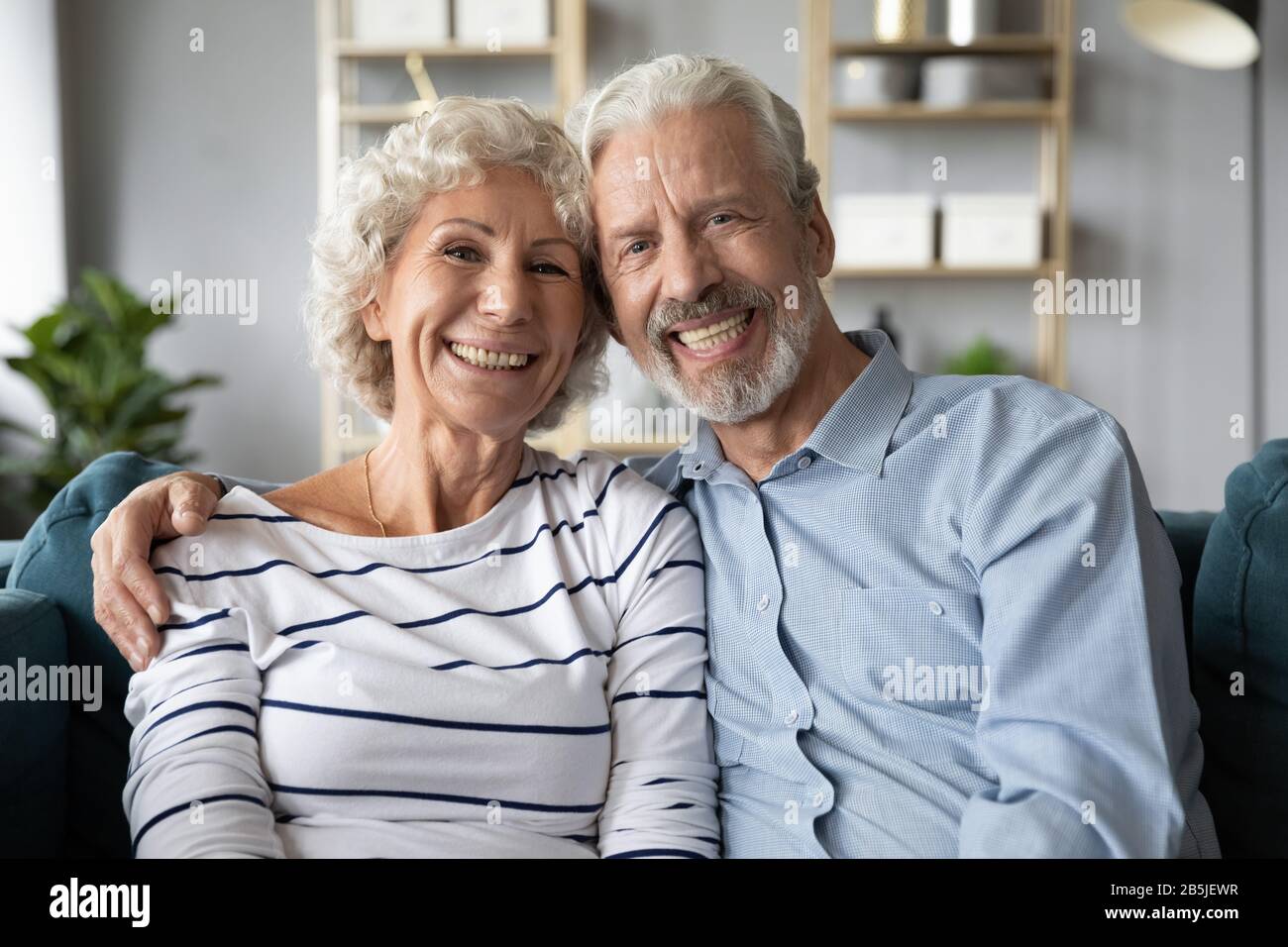 Portrait of happy old couple hug relaxing on couch Stock Photo - Alamy