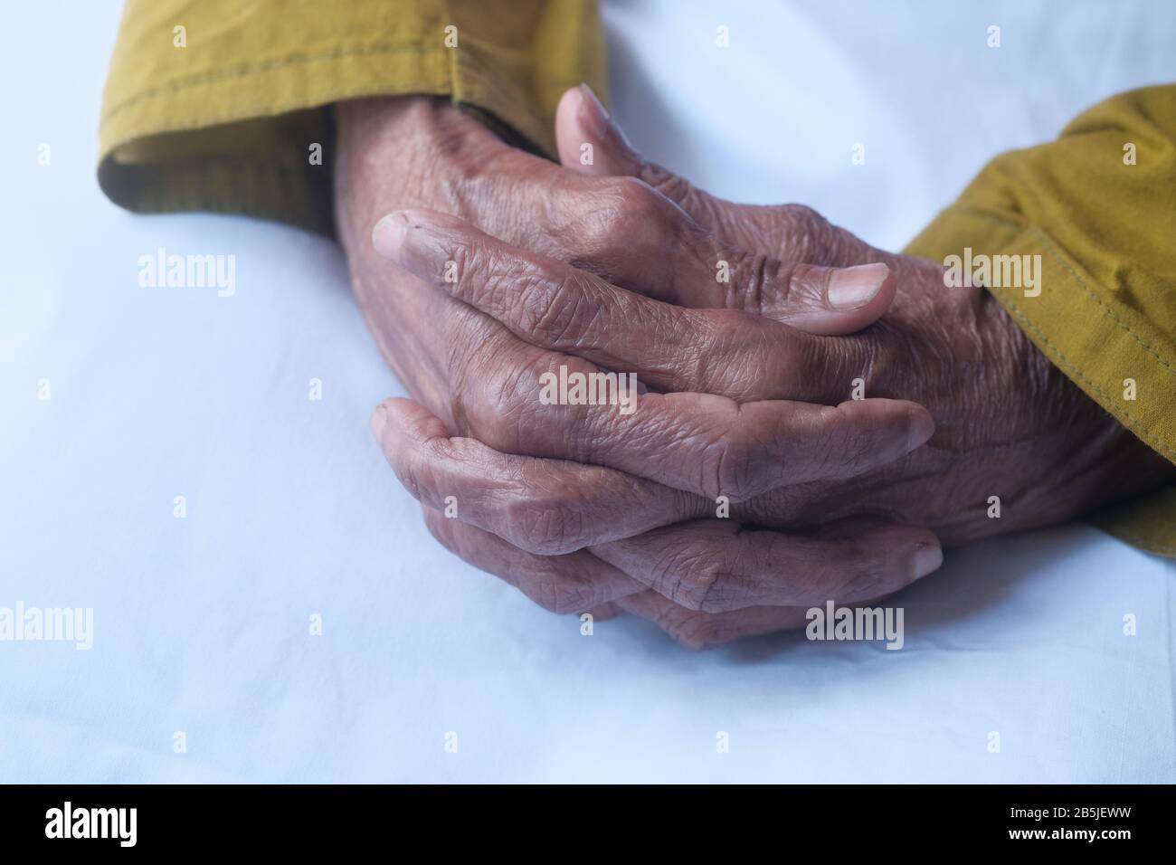 Folded hands dying person hi-res stock photography and images - Alamy