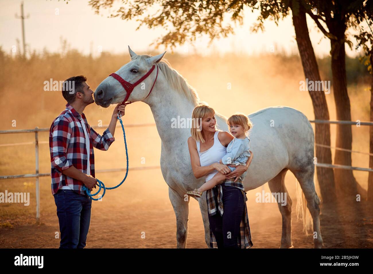 Young family on a horse ranch. People have a fun with a horse Stock ...