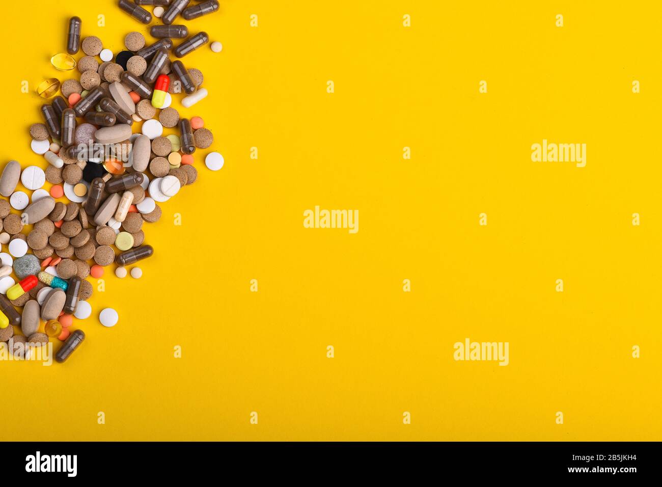 Pills border over yellow, copy space. Medicine and treatment concept ...