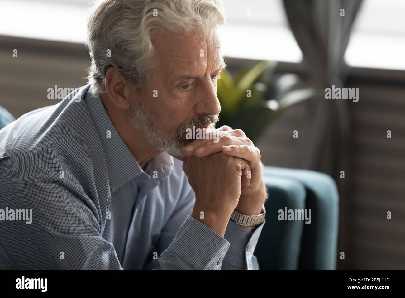 Unhappy elderly man look in distance thinking of past Stock Photo - Alamy