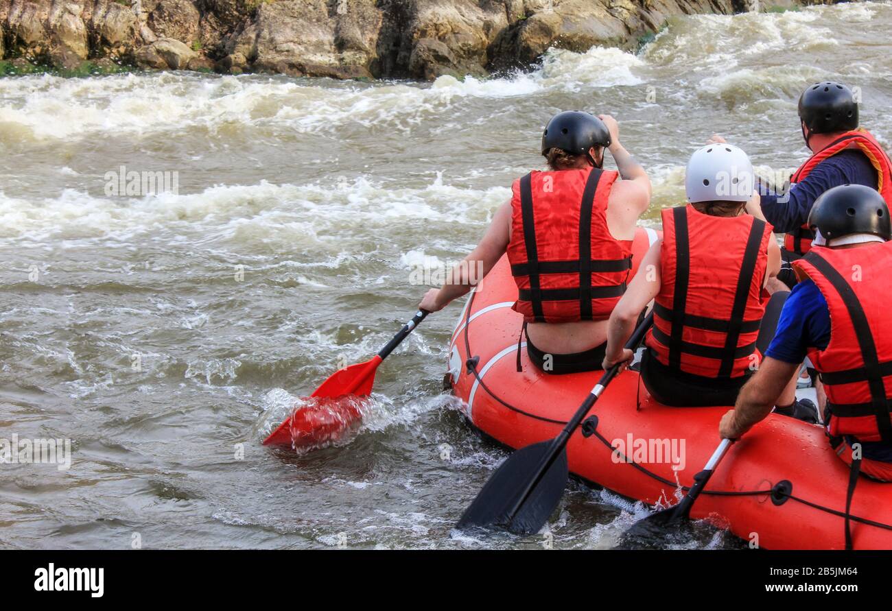 Rafting team , summer extreme water sport. Group of people in a rafting ...
