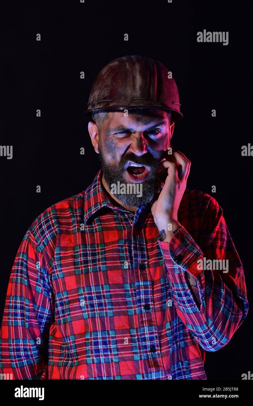 Man with itchy face isolated on black background. Labour and heavy ...