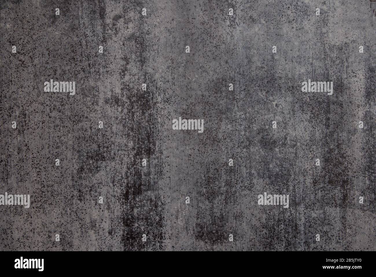Black and dark grey, rough and bumpy concrete wall surface texture with ...