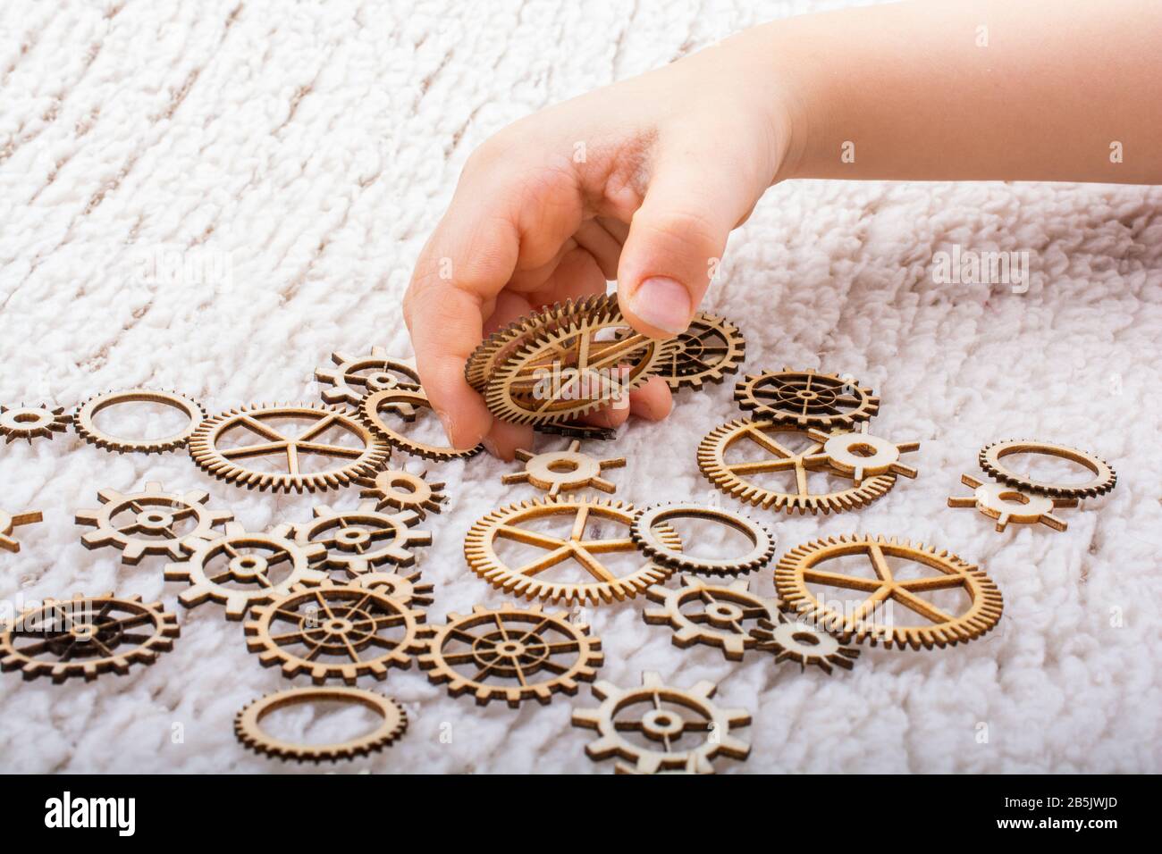 Hand holding gear wheels as the concept of mechanism Stock Photo - Alamy