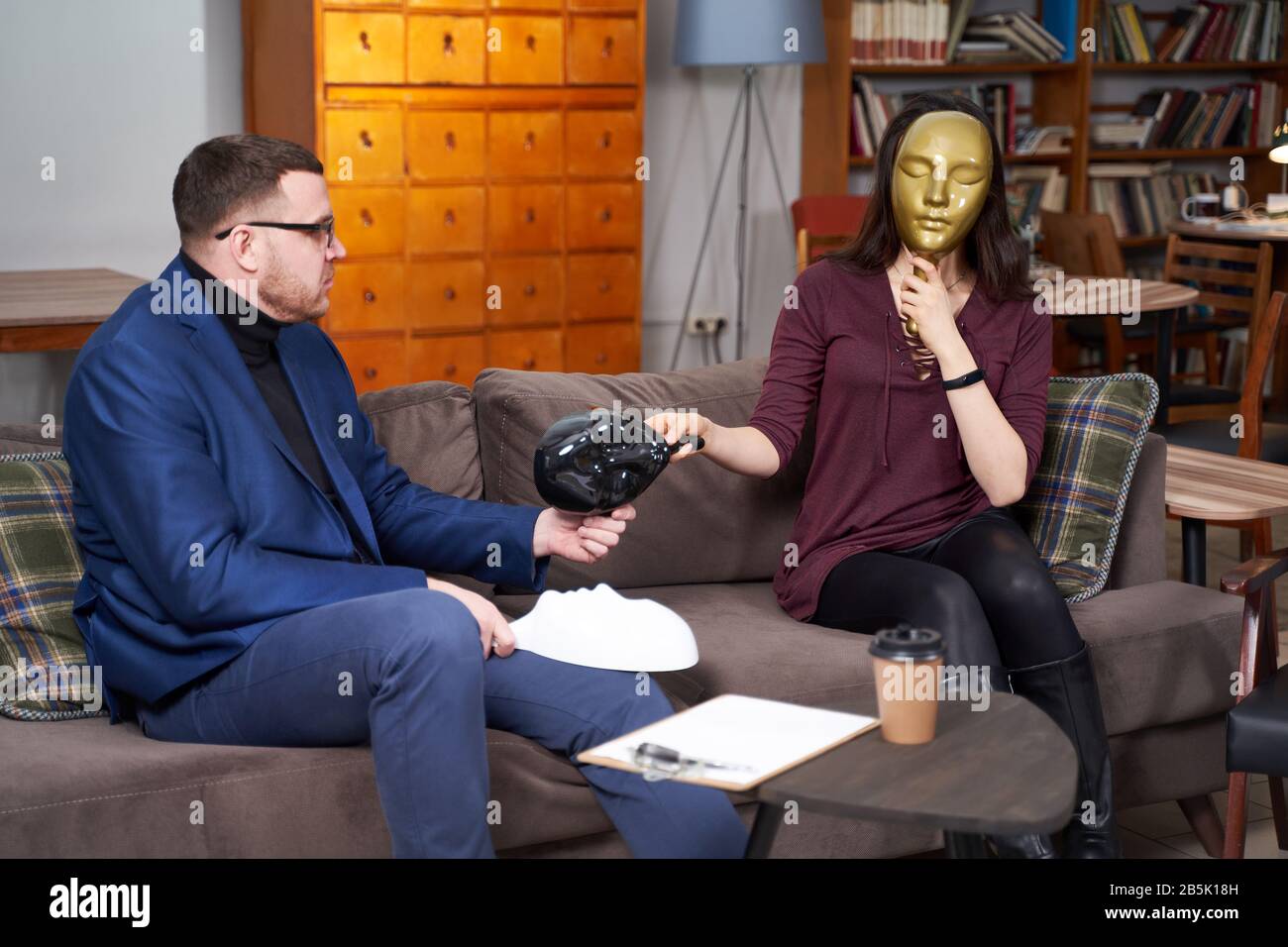 Therapist using plastic masks with female patient during therapy ...