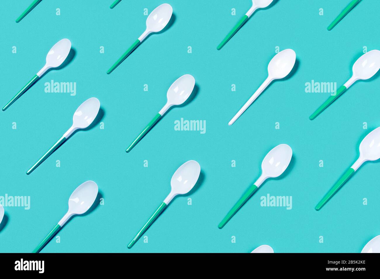 Plastic spoons on tricolor background. Flat lay, top view copy space ...