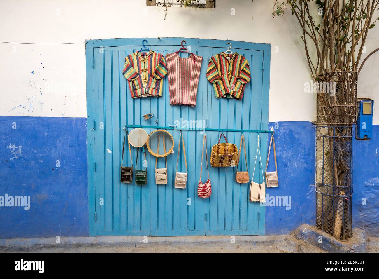 Local items for sale with colorful wooden doors at famous blue city of ...