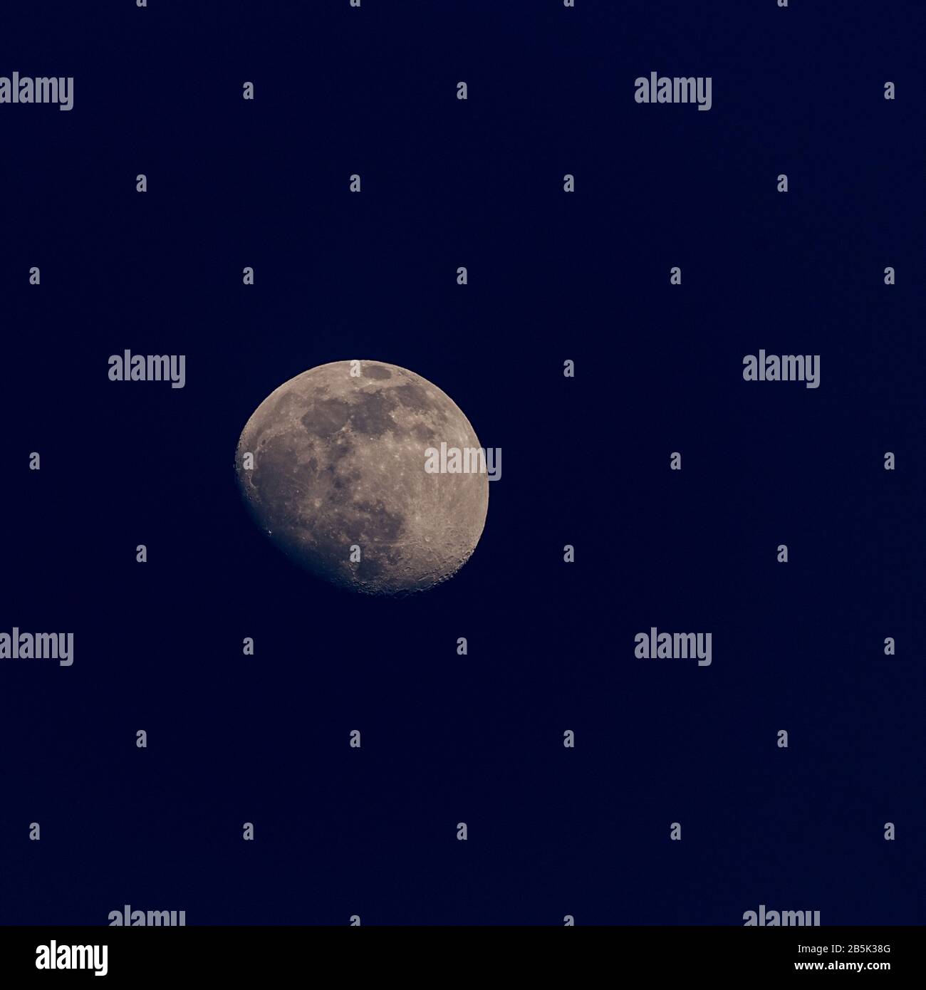 nearly full moon on dark blue background Stock Photo - Alamy