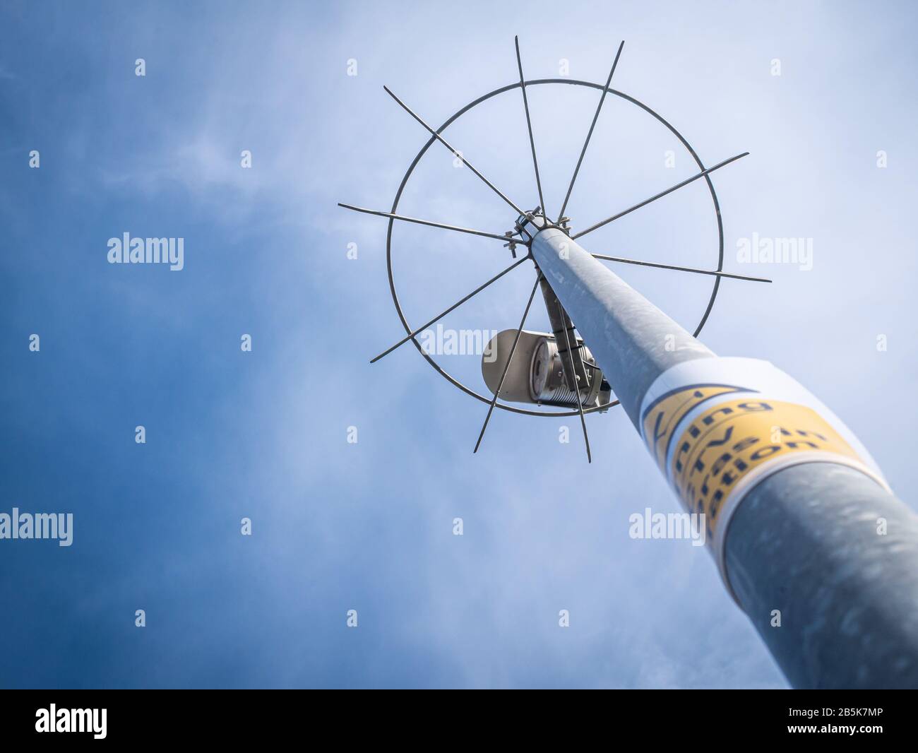 Security camera on pole protected by spikes Stock Photo - Alamy