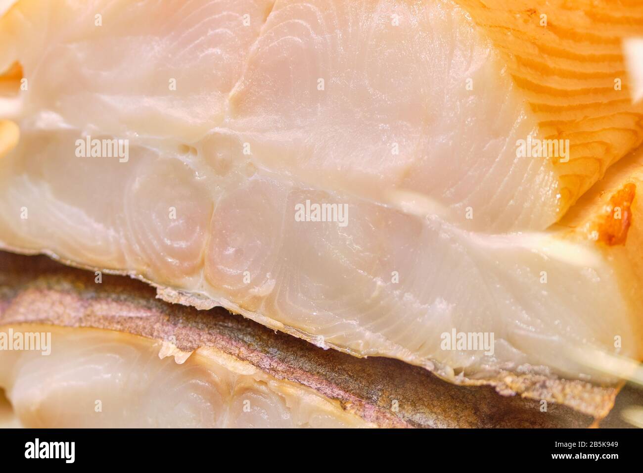 Smoked fish in a cut on a store counter. Close up Stock Photo - Alamy