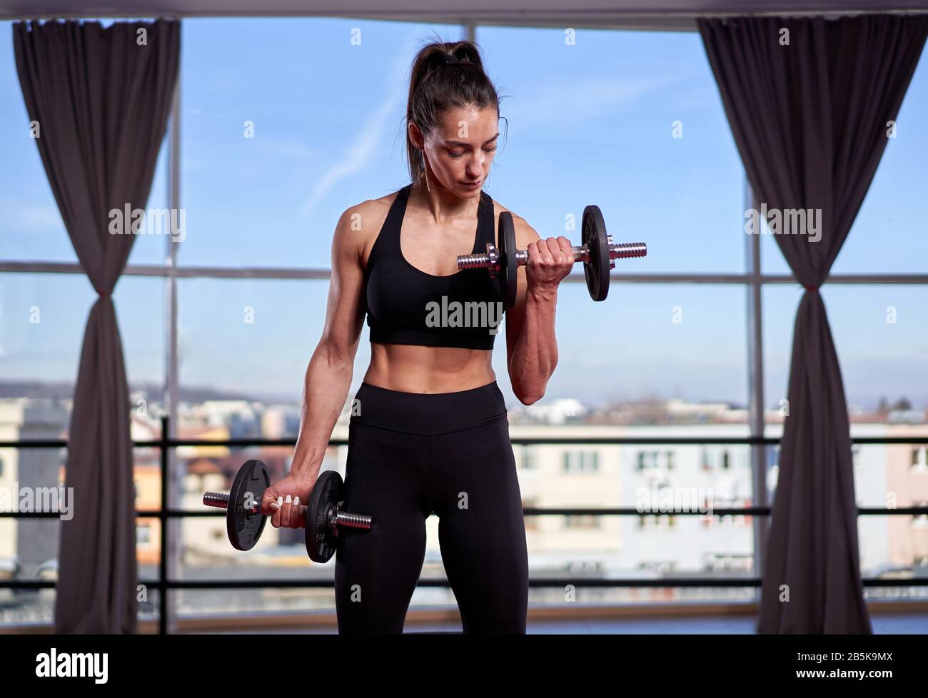 Athletic fitness model woman doing workout in the gym Stock Photo - Alamy