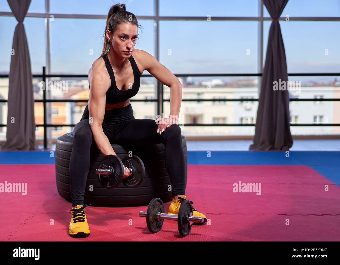 Athletic fitness model woman doing workout in the gym Stock Photo - Alamy