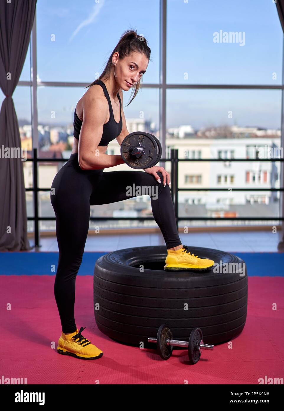 Athletic fitness model woman doing workout in the gym Stock Photo - Alamy