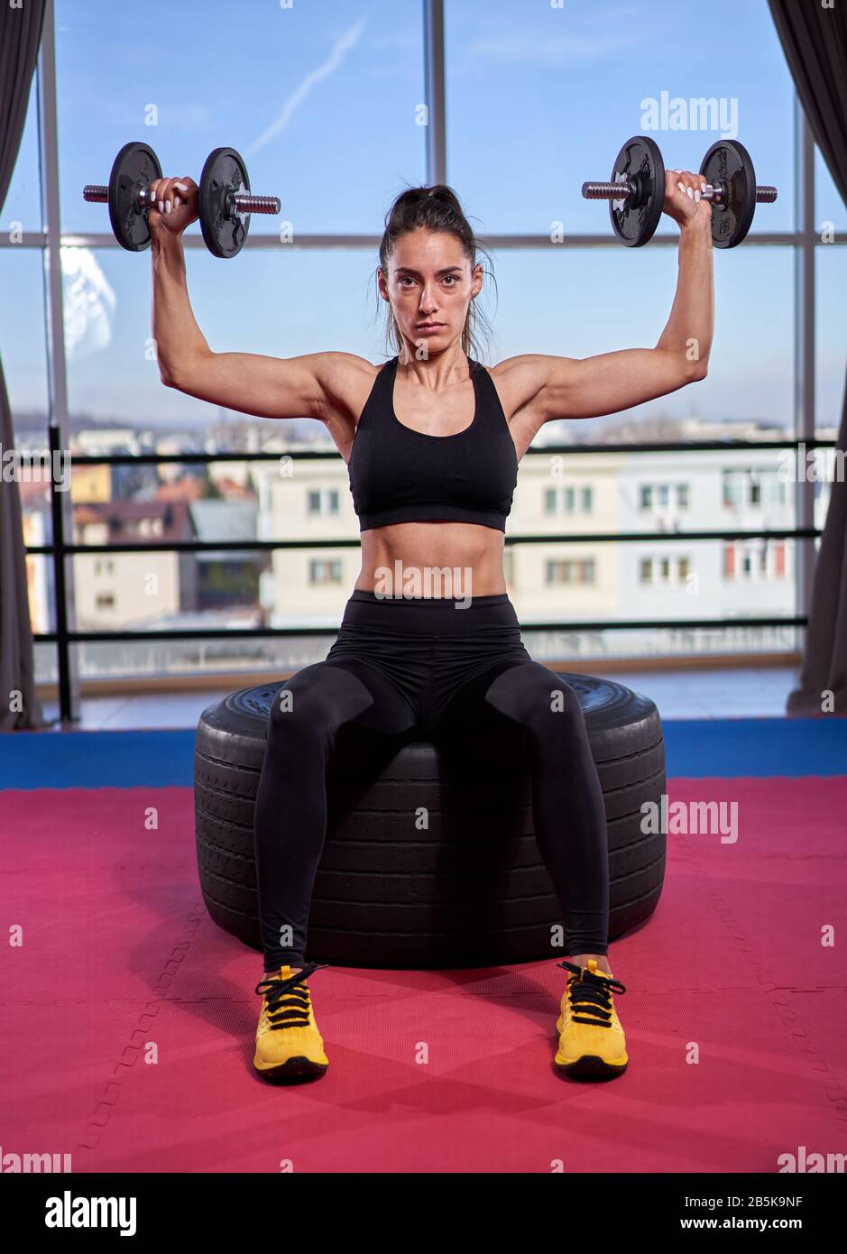 Athletic fitness model woman doing workout in the gym Stock Photo - Alamy