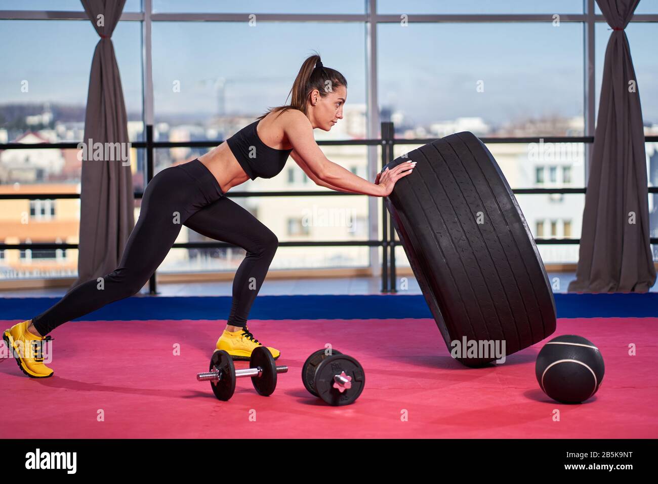 Athletic fitness model woman doing workout in the gym Stock Photo - Alamy