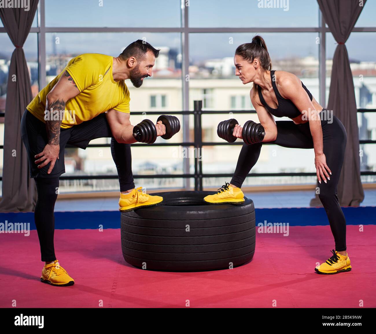 Fit couple doing workout together in the gym Stock Photo - Alamy