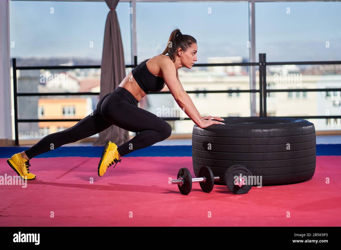 Athletic fitness model woman doing workout in the gym Stock Photo - Alamy