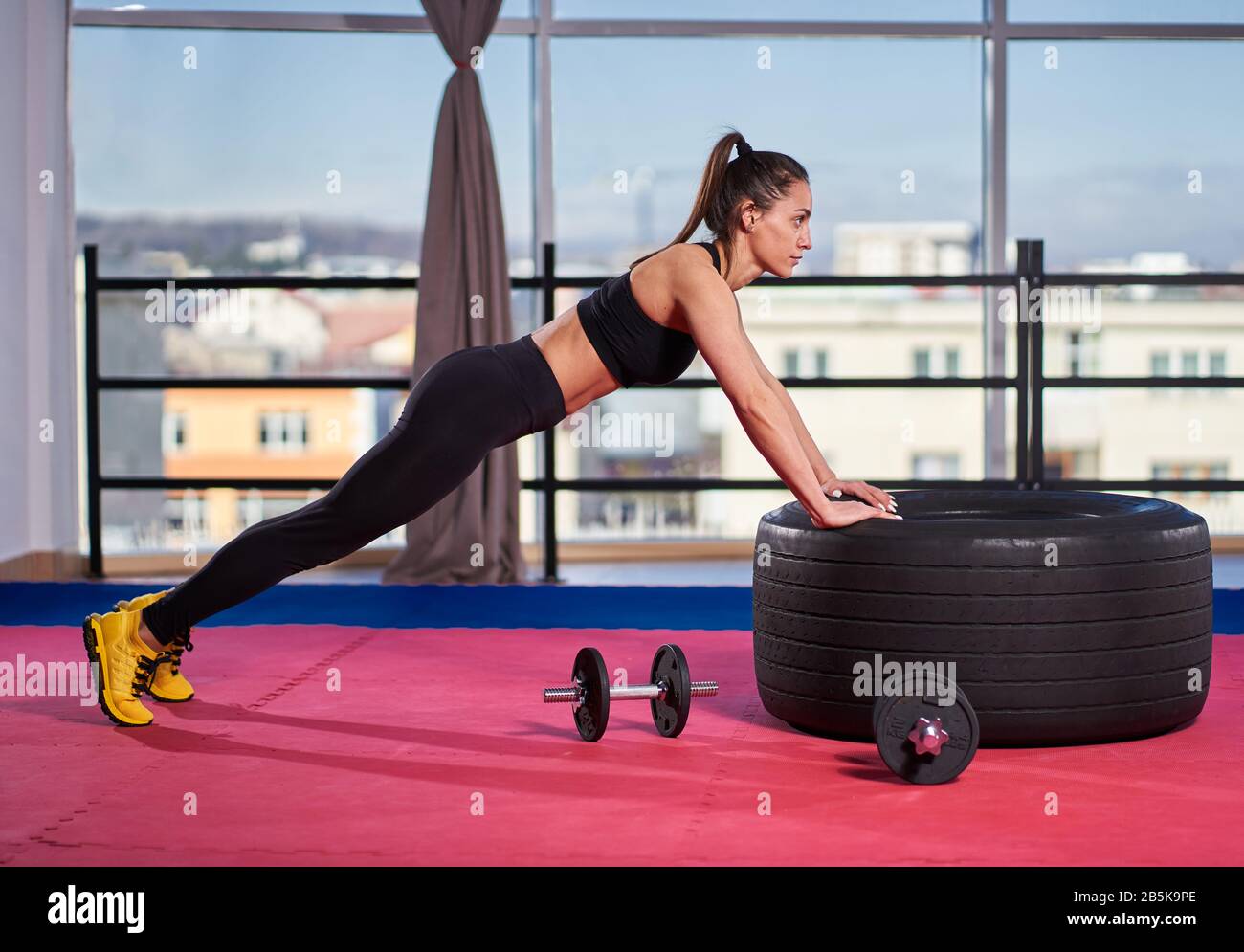 Athletic fitness model woman doing workout in the gym Stock Photo - Alamy