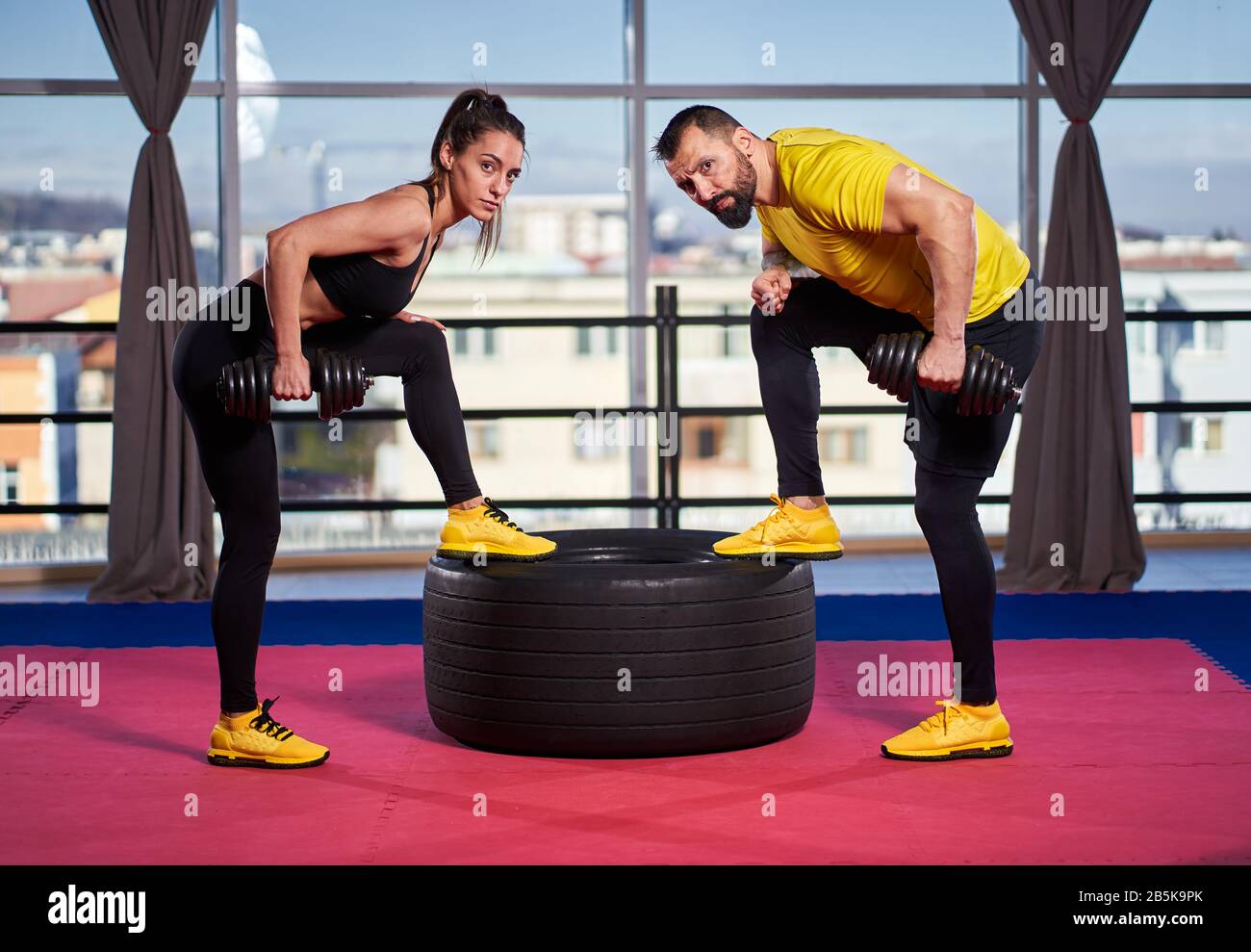 Fit couple doing workout together in the gym Stock Photo - Alamy