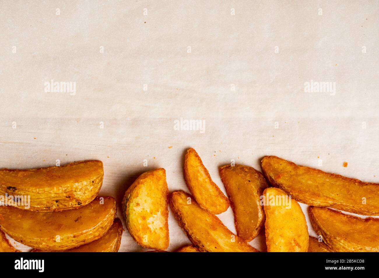 Rustic fried potatoes on a paper background. Top view. Copy space Stock ...