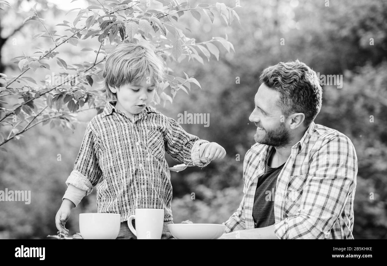 Father teach son eat natural food. Little boy and dad eat. Organic ...