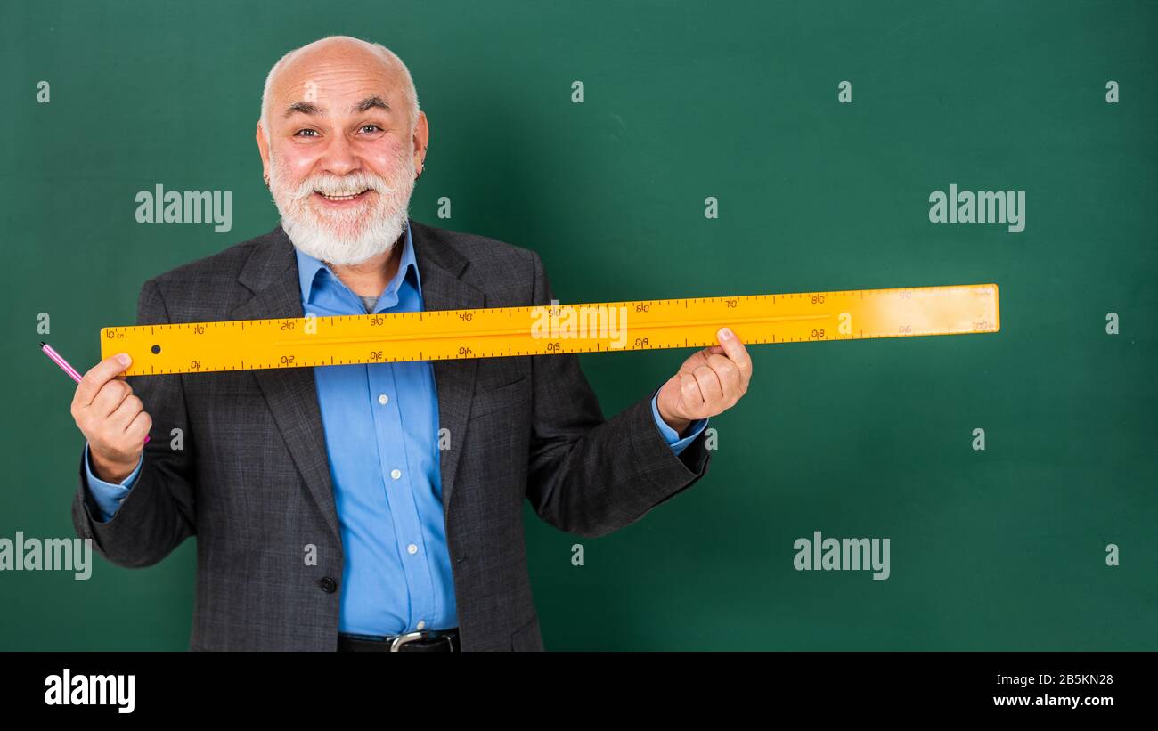size measure. senior man teacher use ruler while drawing. happy tutor ...