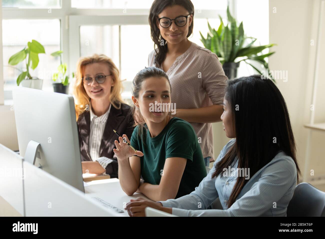 Multiracial female colleagues brainstorm at office workplace together ...